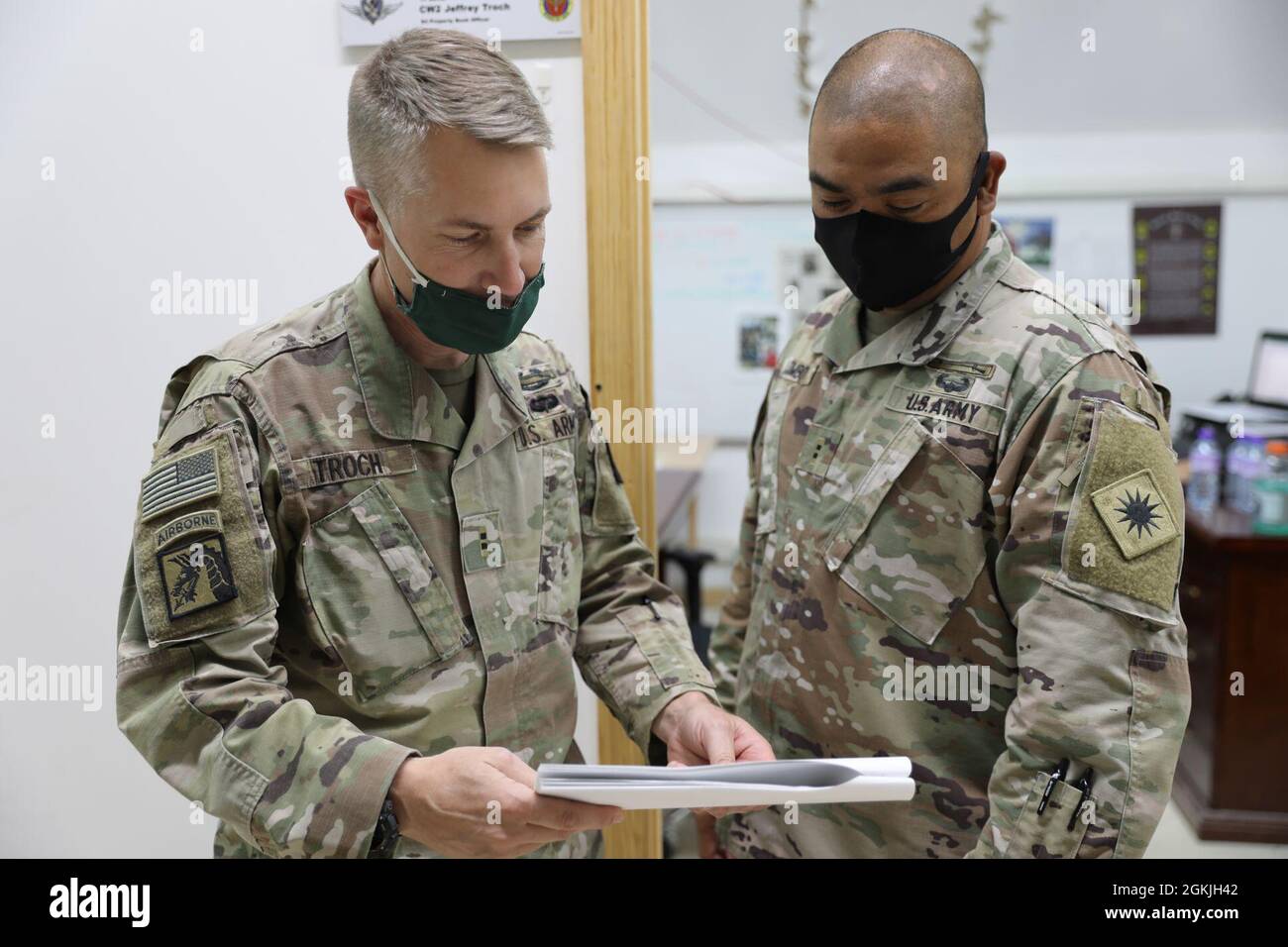 Chief Warrant Officer 2 Jeffrey Troch (left), the Property Book Officer ...