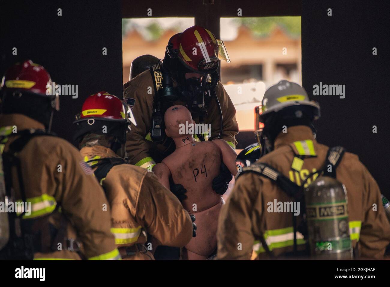 Firefighters with the 374th Civil Engineer Squadron rescue a simulated ...