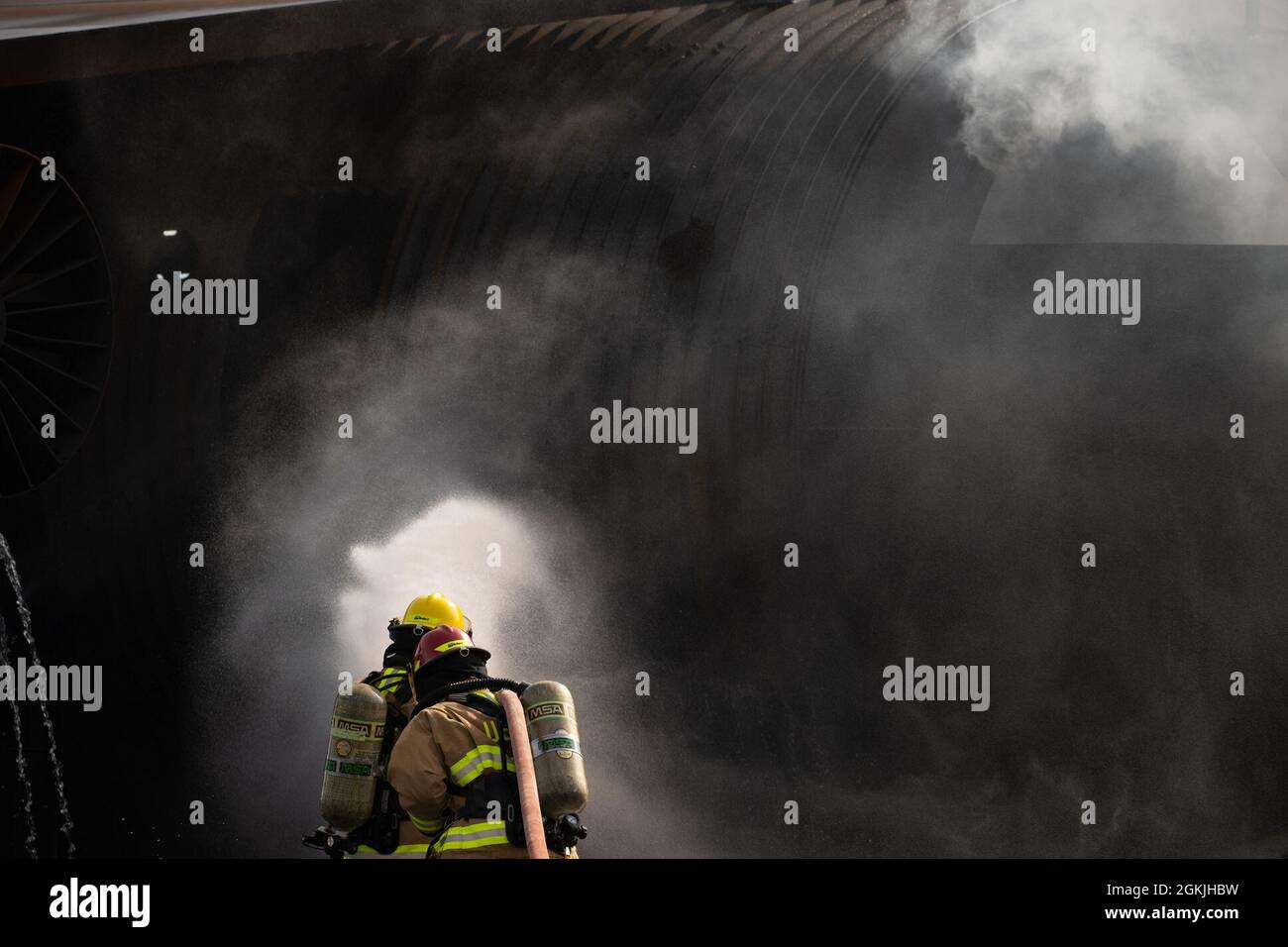 Firefighters with the 374th Civil Engineer Squadron battle a simulated ...