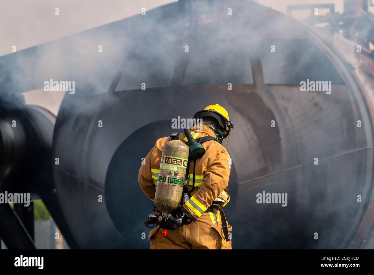 A firefighter with the 374th Civil Engineer Squadron secures his gear ...