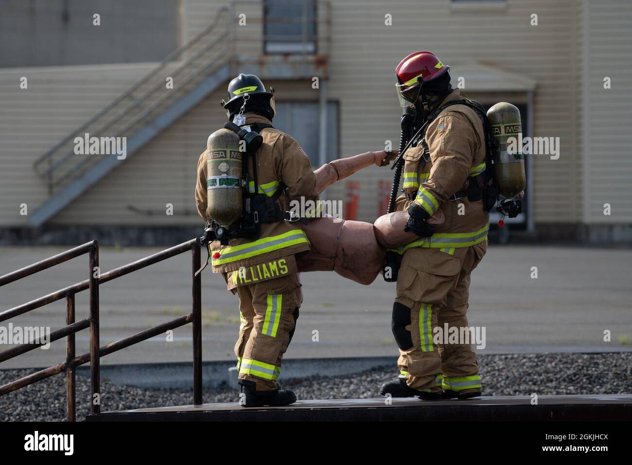 Firefighters with the 374th Civil Engineer Squadron carry a simulated ...
