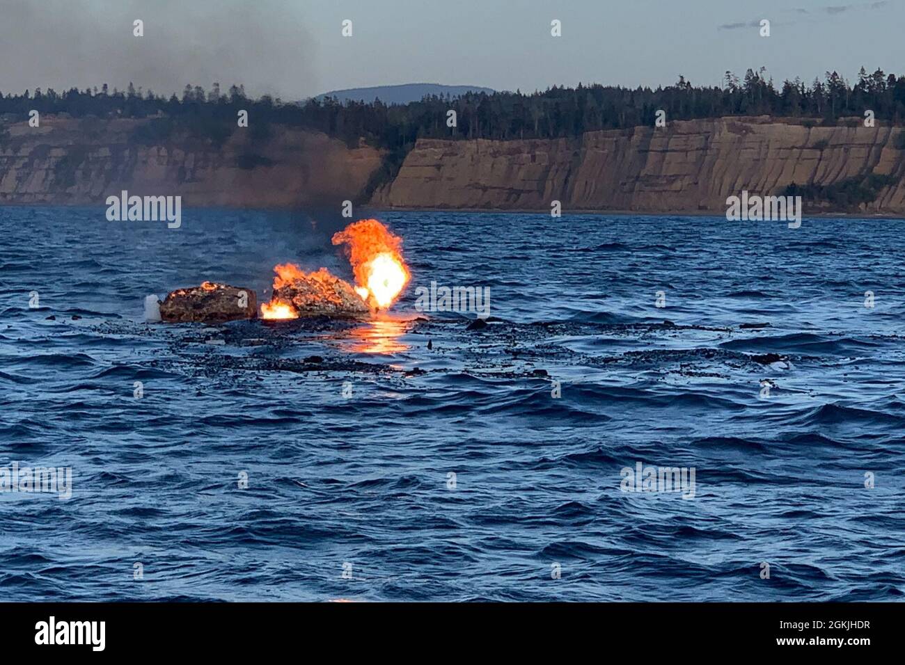 Debris burns after a boat fire resulted in the sinking of a 48-foot ...