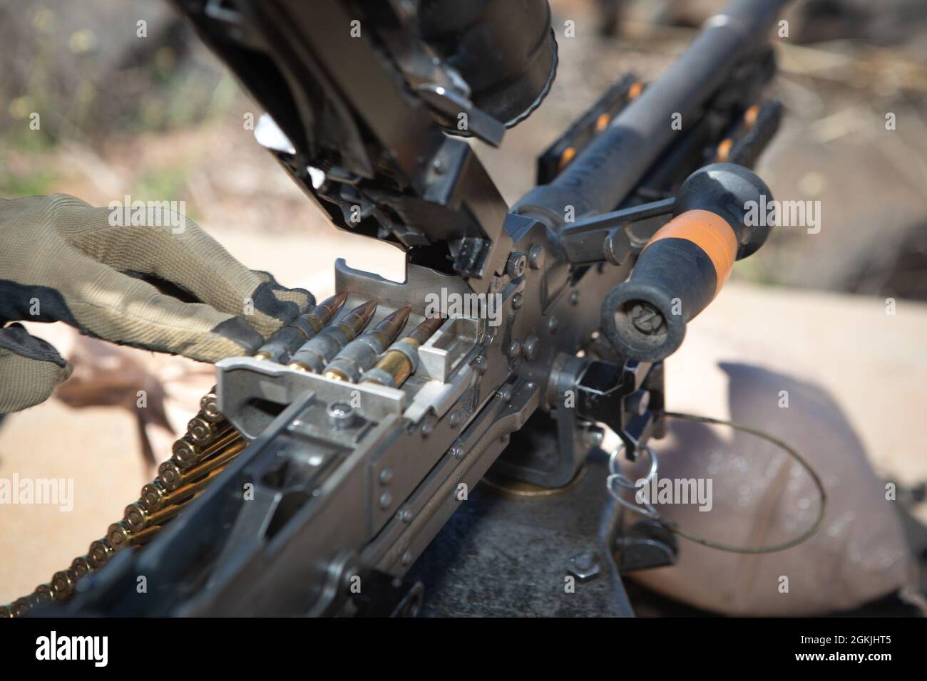A U.S. Marine with Marine Rotational Force - Darwin loads a M240B ...