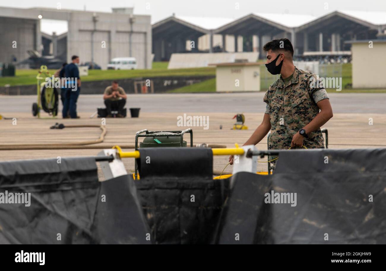 A U.S. Marine from the Marine Wing Support Squadron 172, assists in a ...