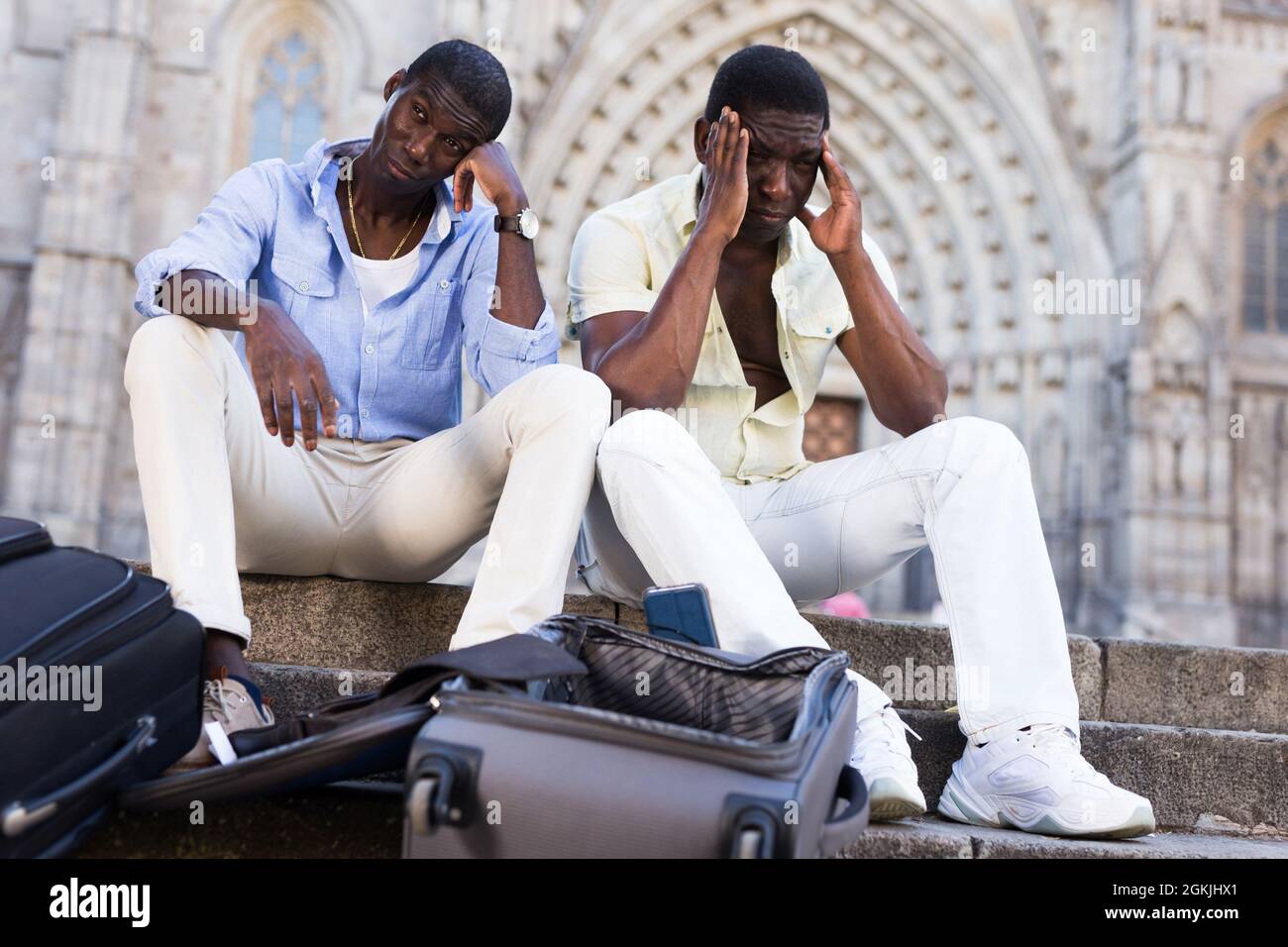 Weary tourists rest on stone staircase after sightseeing Stock Photo ...