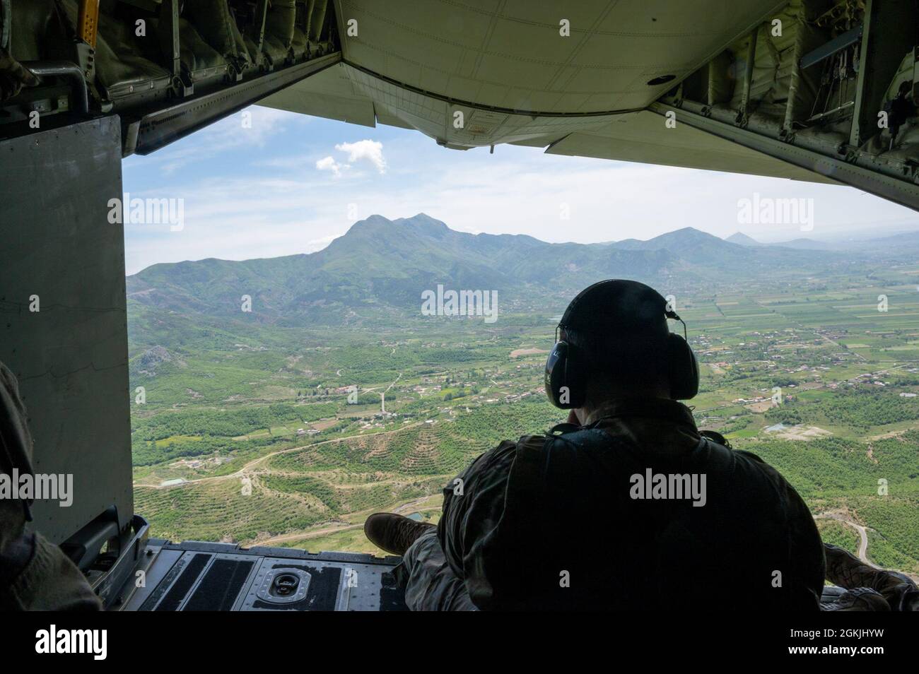 A U.S. Air Force member sits on the ramp of a MC-130J Commando II ...