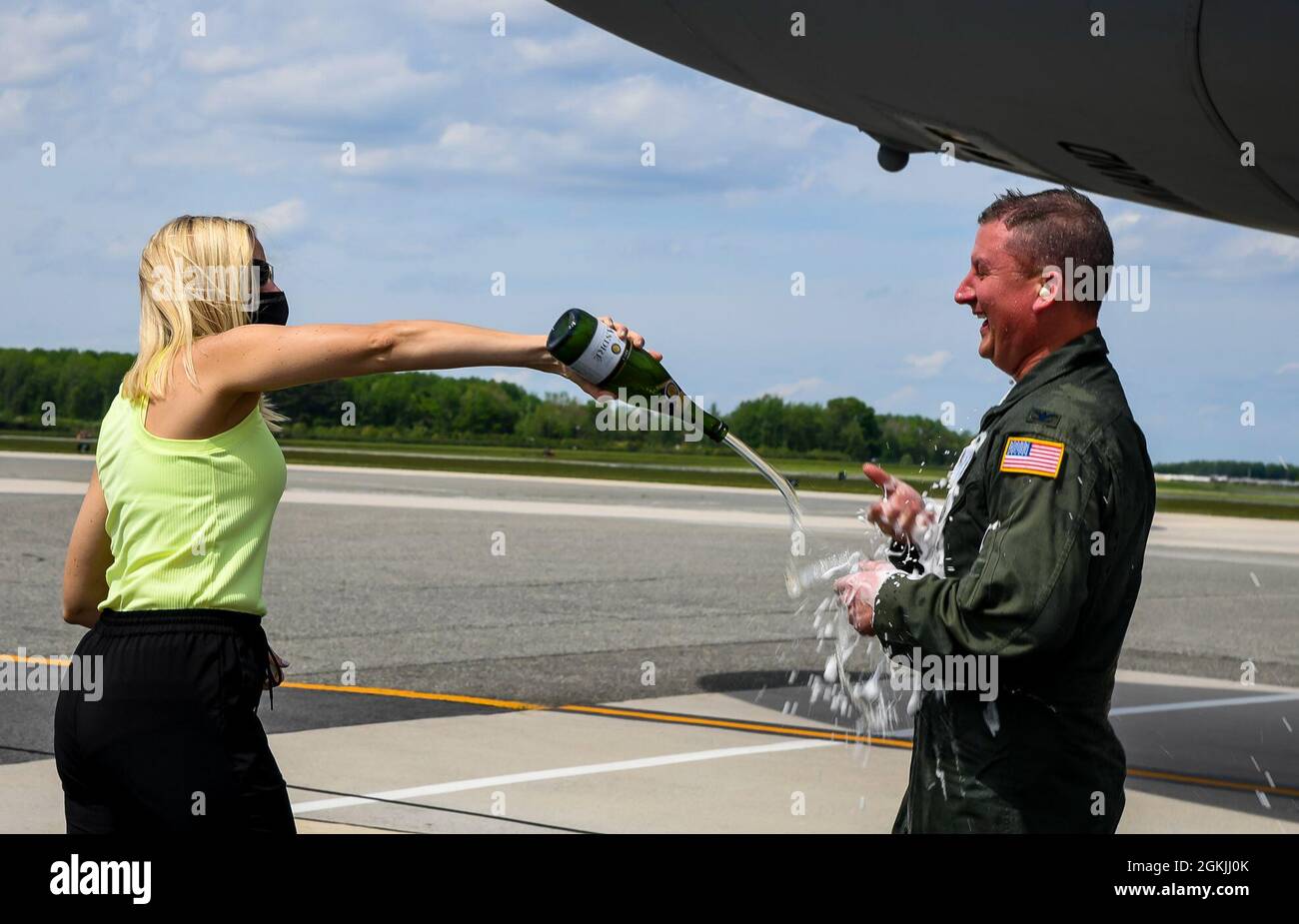 Christie Jones pours champagne on her husband, Col. Matthew Jones ...