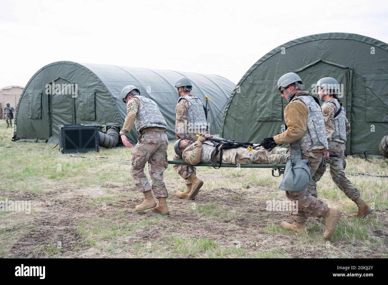 Members of the 819th RED HORSE Squadron carry an Airman on a stretcher ...