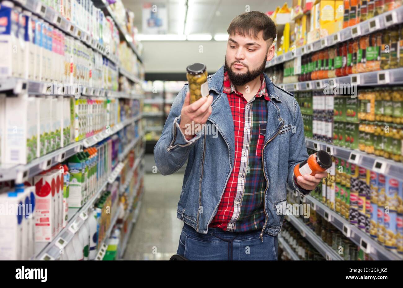 Guy shopping pickles at grocery store Stock Photo - Alamy