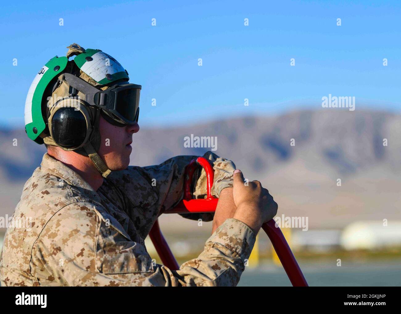 A U.S. Marine observes a hot pit refueling on the Marine Corps Air ...