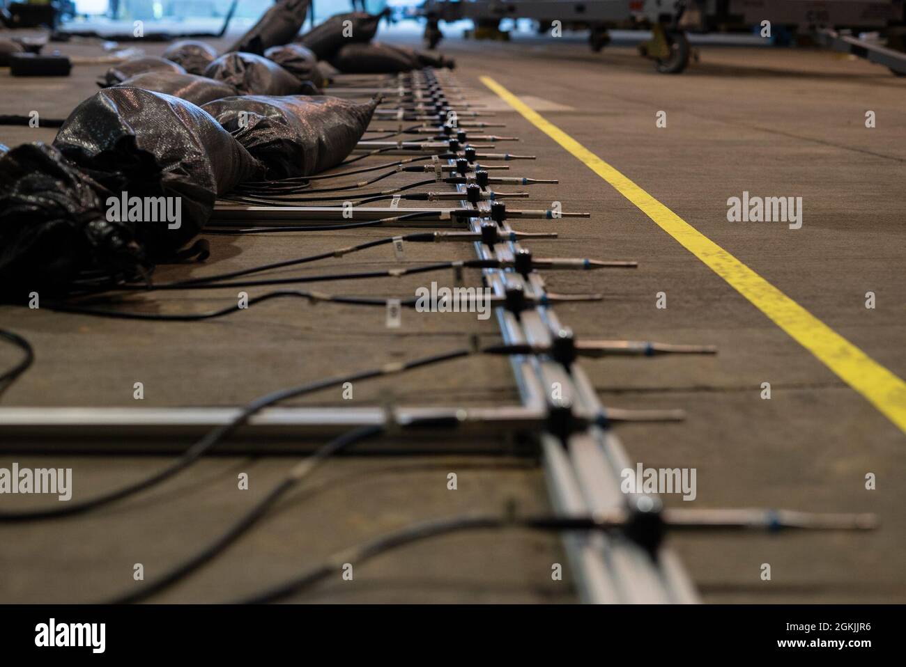 Acoustic testing sensors line the ground of a protective aircraft ...