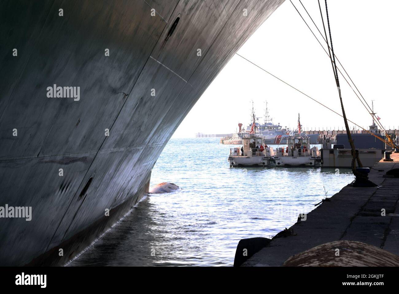 The U.K. HURST POINT cargo vessel dwarfs U.S. Navy tugboats at the Port ...