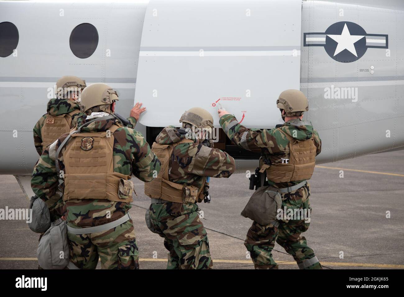 Patrolmen with the 374th Security Forces Squadron open a rear door of a ...