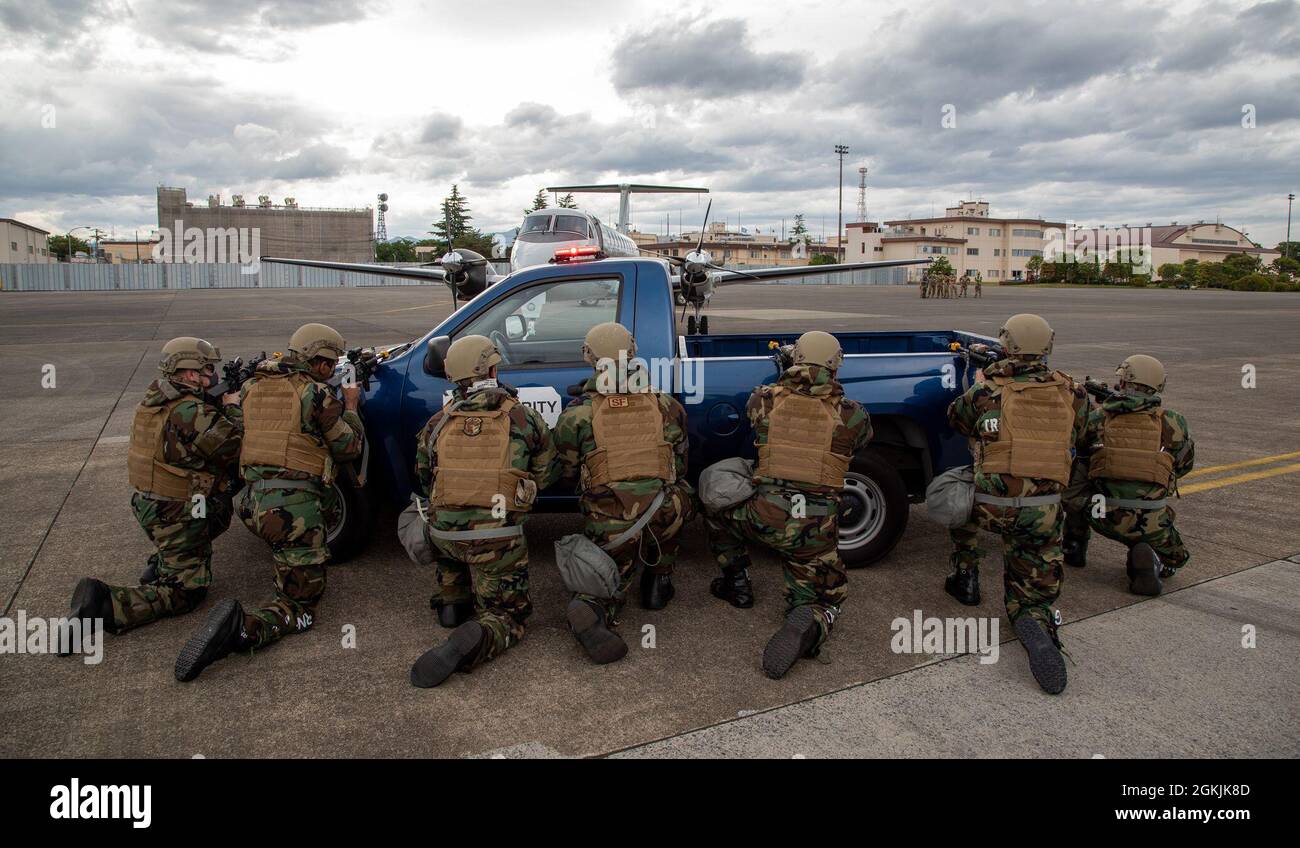 Patrolmen with the 374th Security Forces Squadron secure a C-12 Huron ...