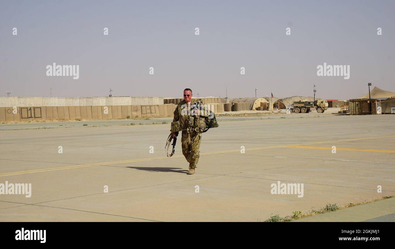 Chief Warrant Officer 3 Timothy Shaner walks the flight line to a ...