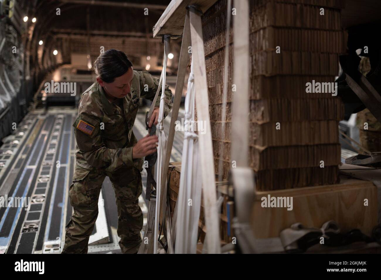 Army Sergeant Inna Yi from the 151QM, inspects a cargo load aboard a C ...