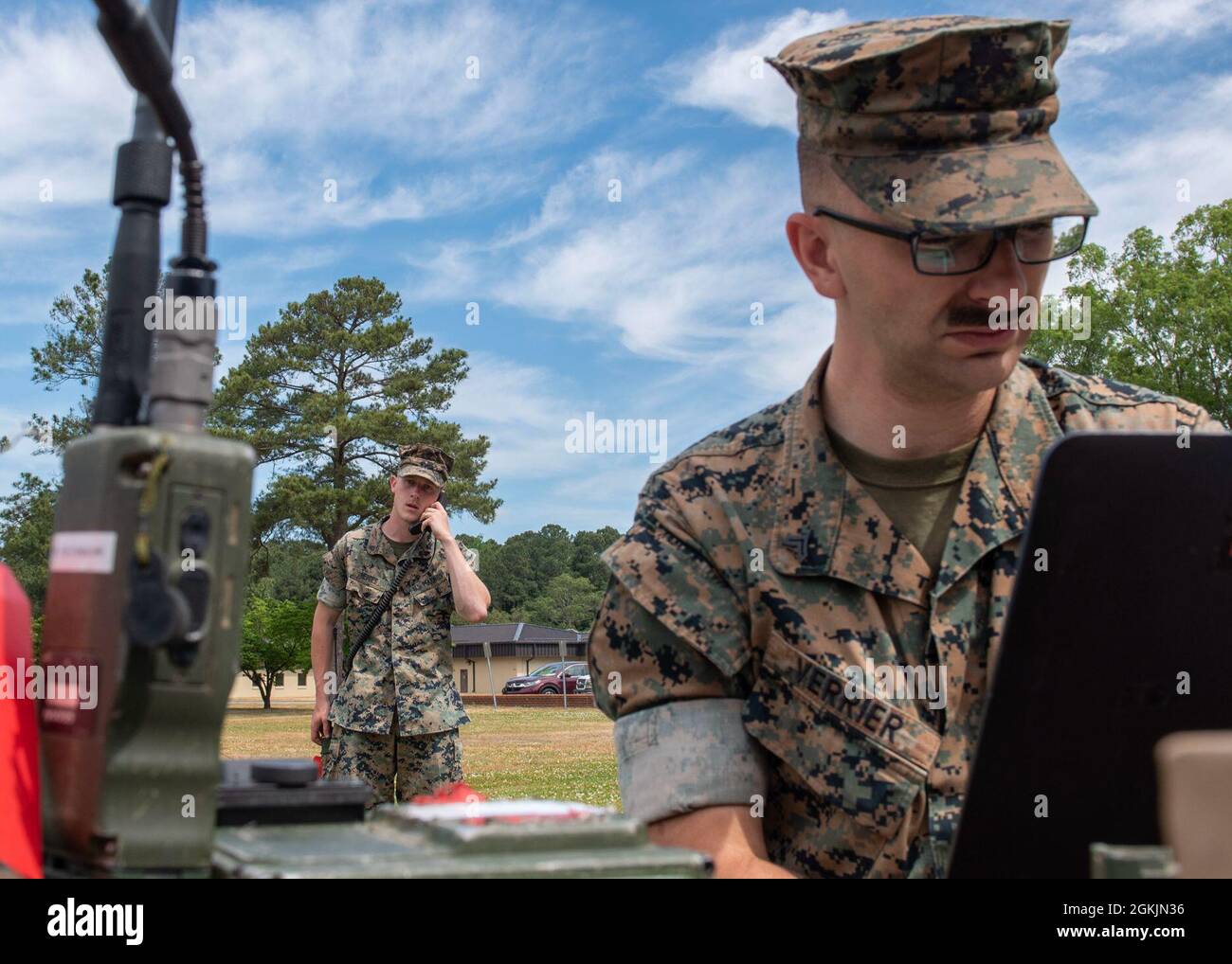 Cpl. Zachary Verrier, right, programs a secure communications ...