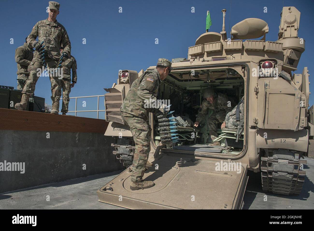 Soldiers begin loading a Bradley Fighting Vehicle with ammunition in ...