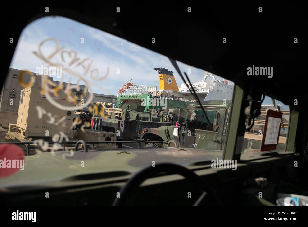 British cargo ship Hurst Point is docked behind a convoy of U.S ...