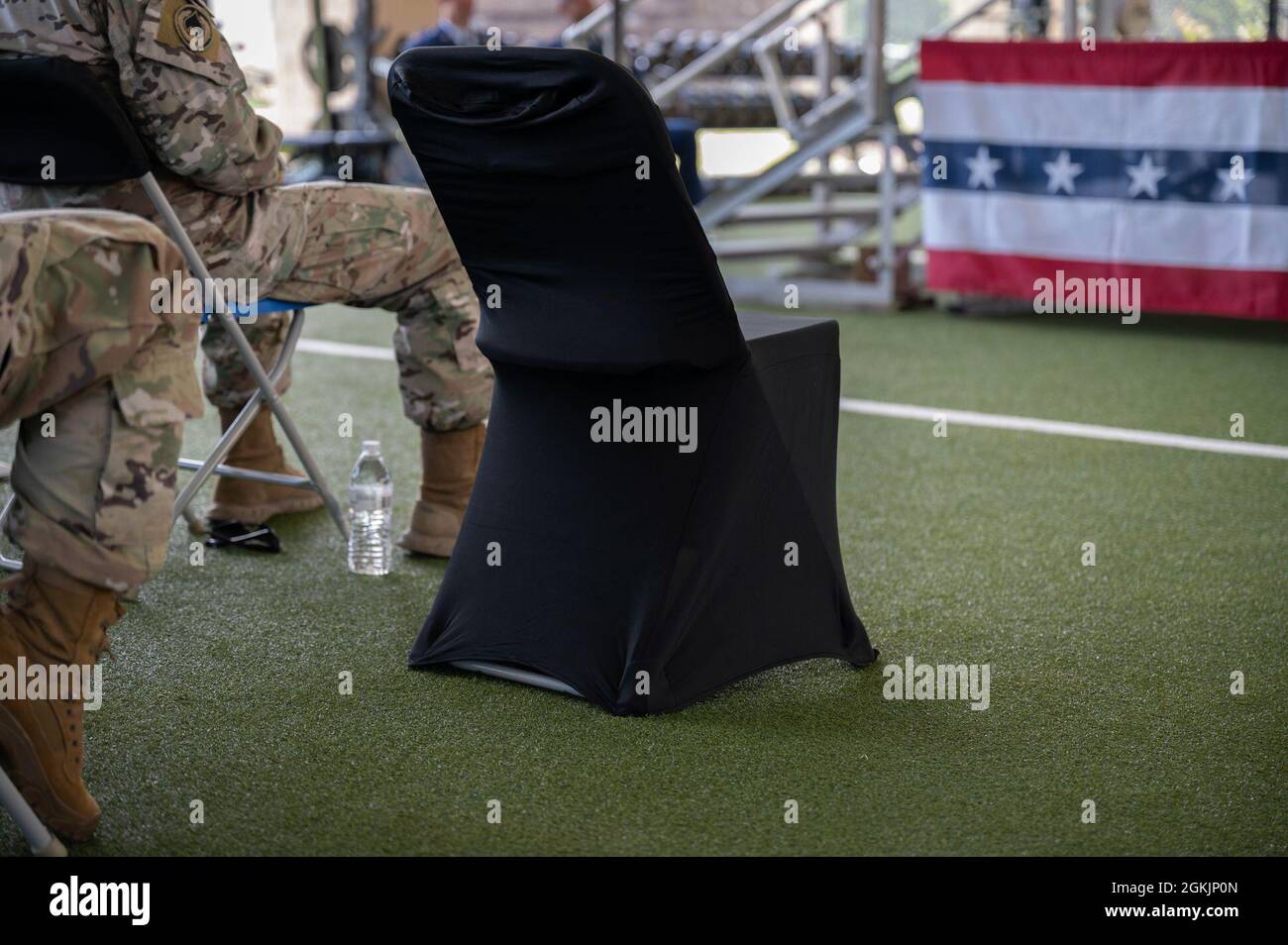 An empty chair represents fallen soldiers during a building dedication ...