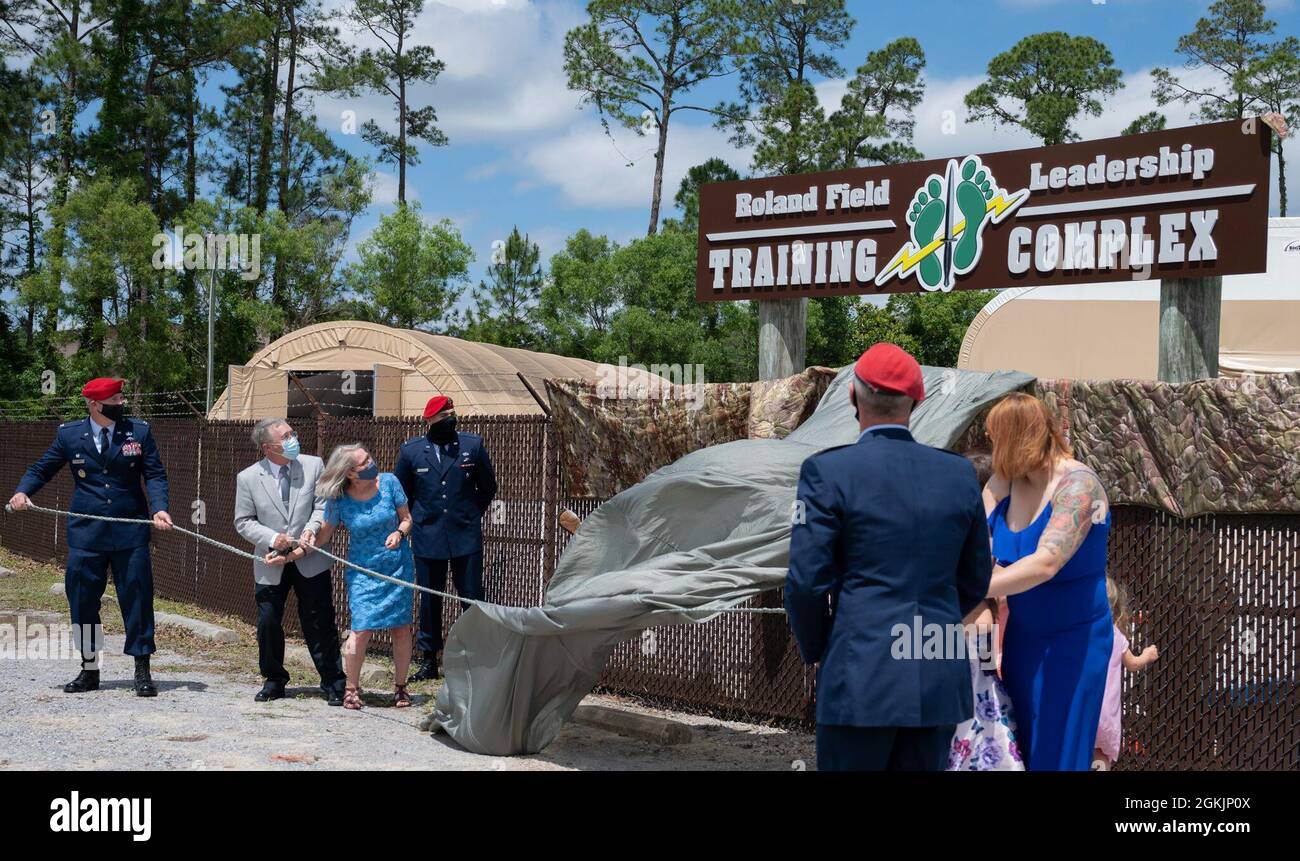 The family of U.S. Air Force Capt. Matthew Roland unveils a sign during ...