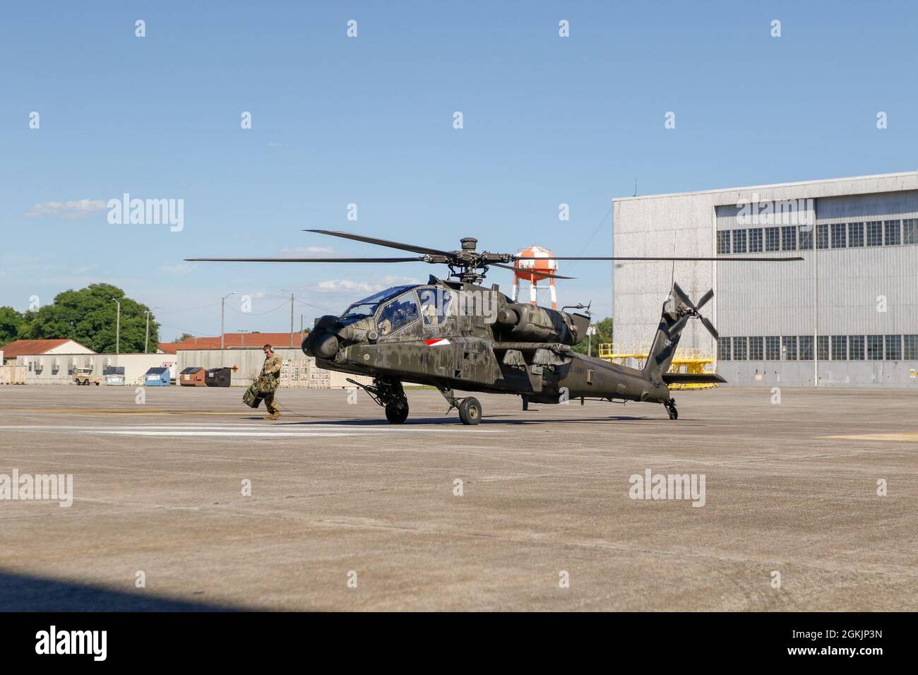 An AH-64D Apache helicopter sits on the flight line as Lt. Col. Lee ...