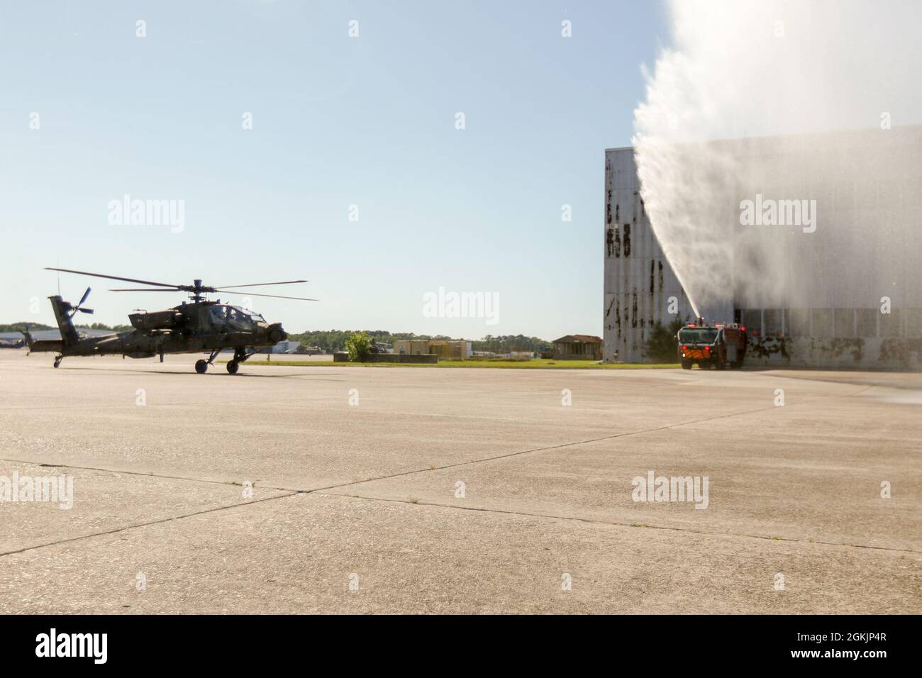 An AH-64D Apache helicopter gets hosed down as Lt. Col. Lee Robinson ...