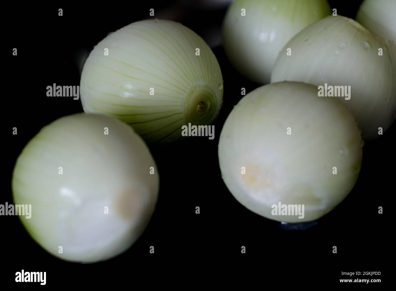 Five fresh onions on a table for consumption. Onion is the most ...