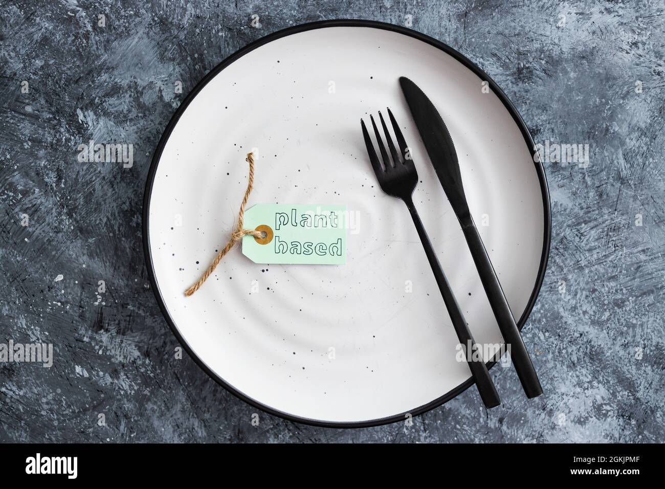 plant-based product tag on top of dining plate with fork and knife ...