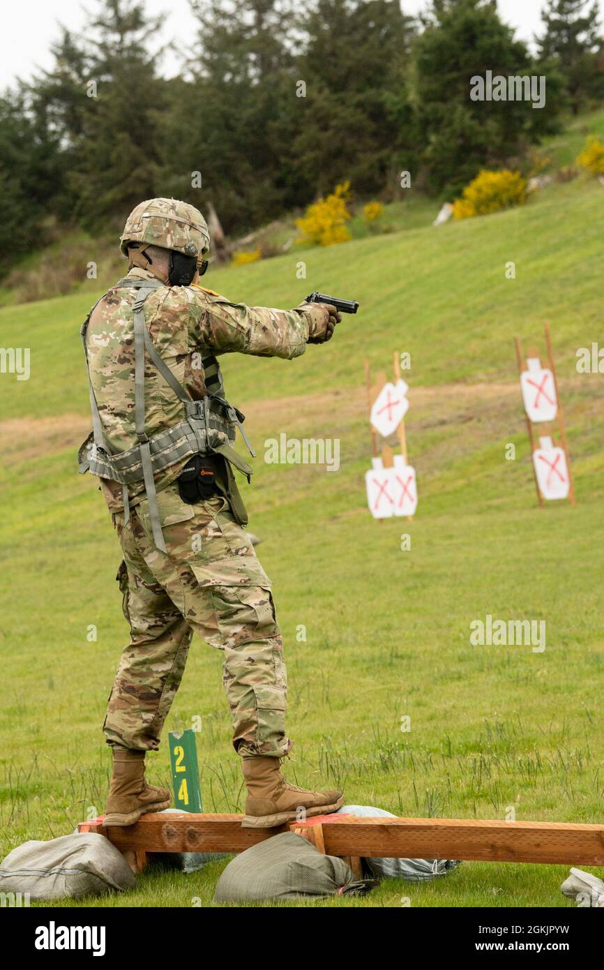 Alaska Army National Guard Sgt. Hector Colon fires his pistol while ...