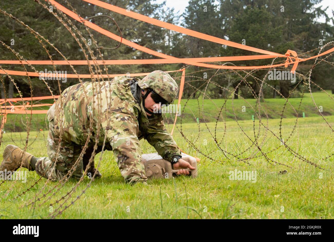 Wyoming Army National Guard Spc. Aiden Carroll, low crawls under an ...