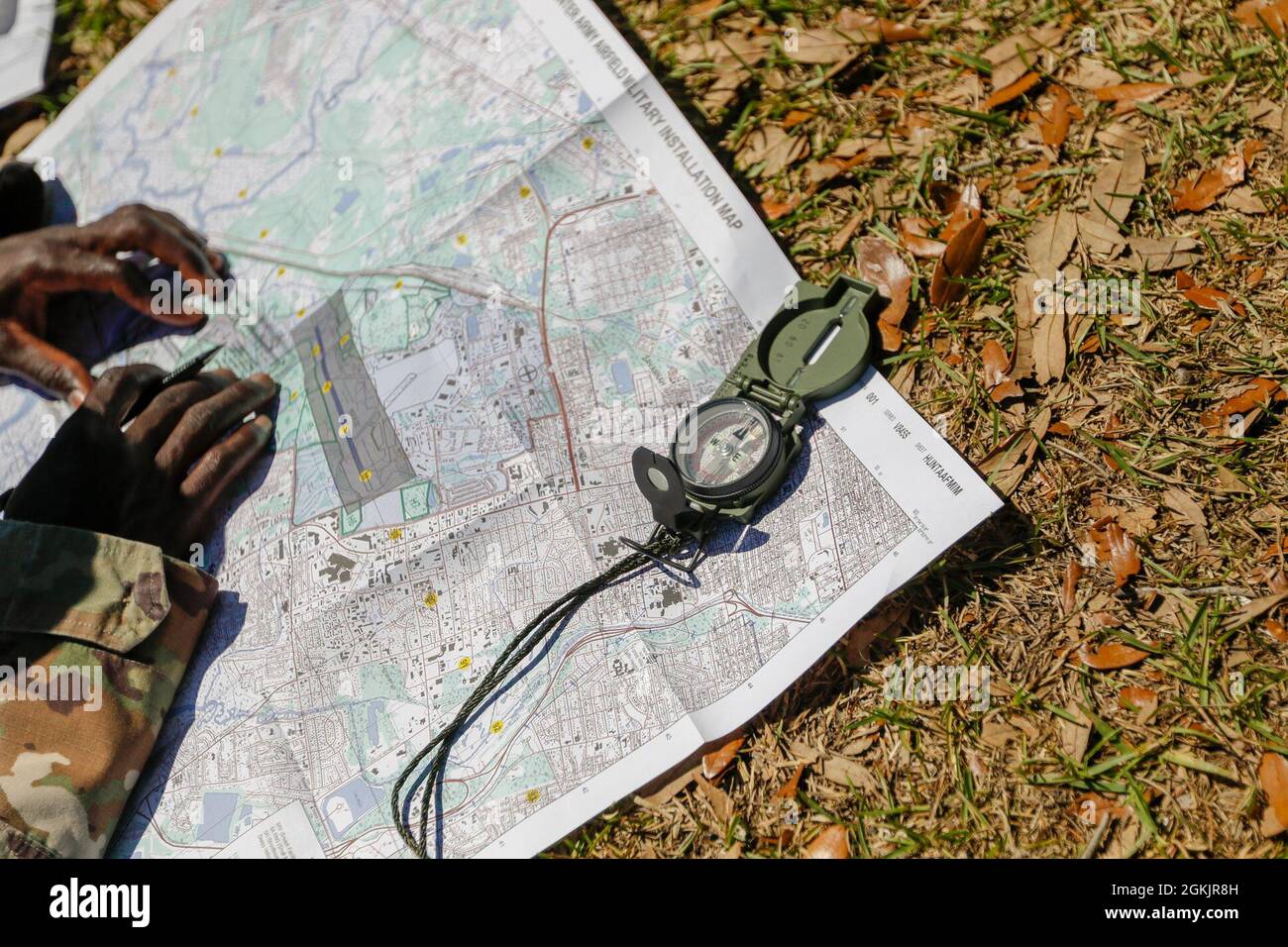 A compass sits on a map during the land navigation portion of the 3rd ...