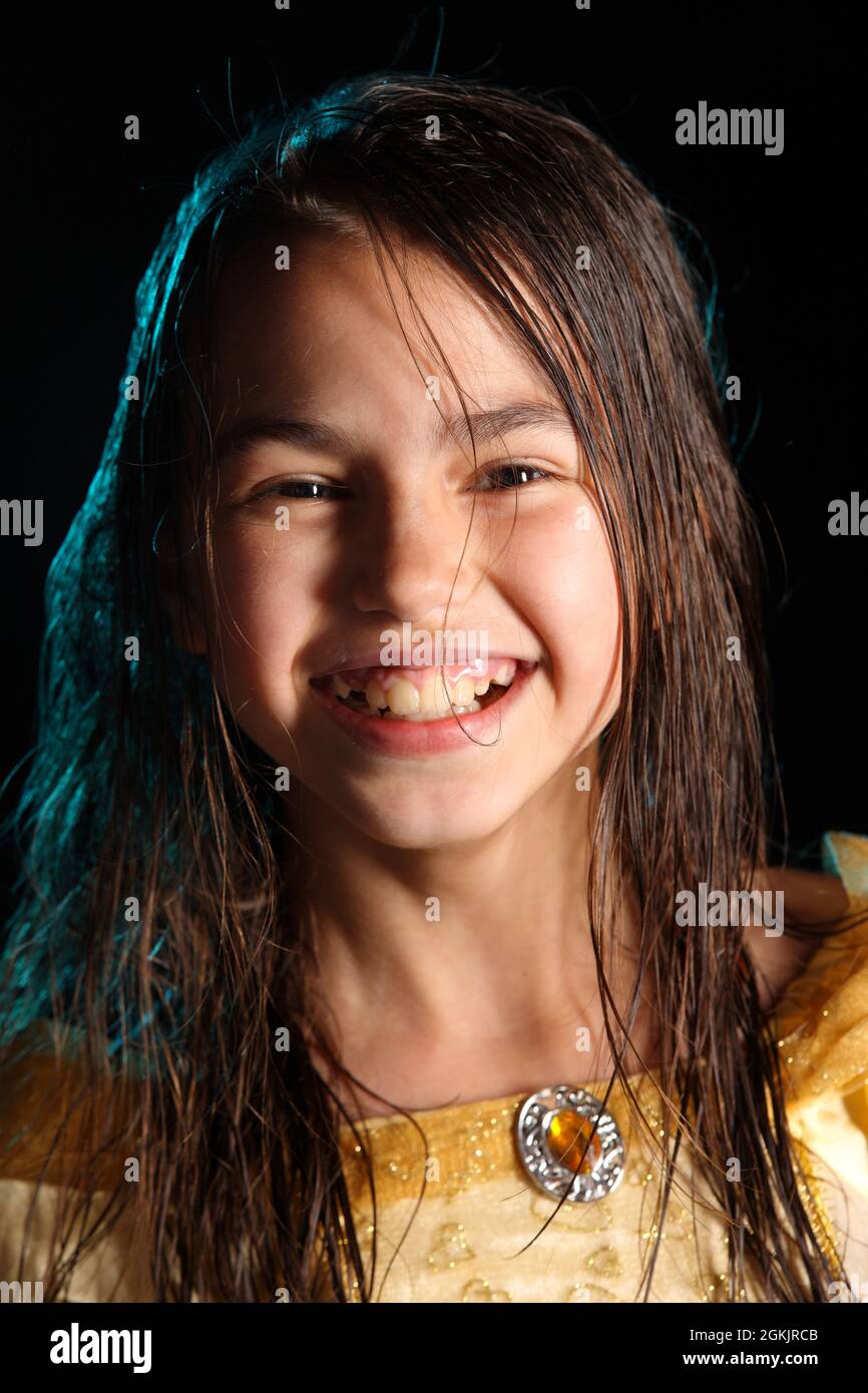Close Up Portrait Of A Bright Cute Brunette 12 Years Old In A Yellow