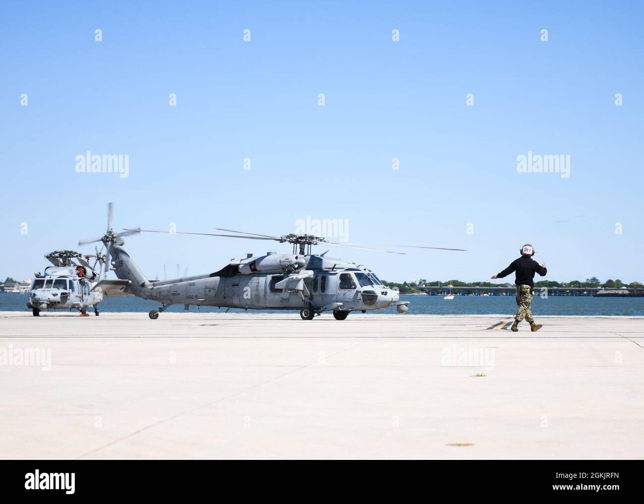 A Sailor assigned to Helicopter Sea Combat Squadron 11 (HSC-11) directs ...