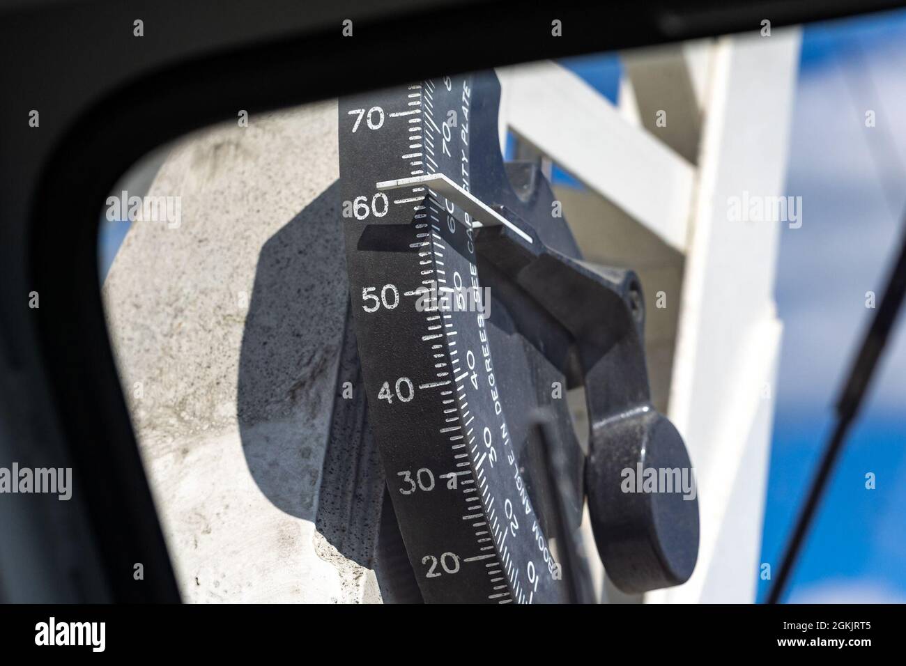 The boom angle indicator on a crane moving rocks to build reefs in the ...