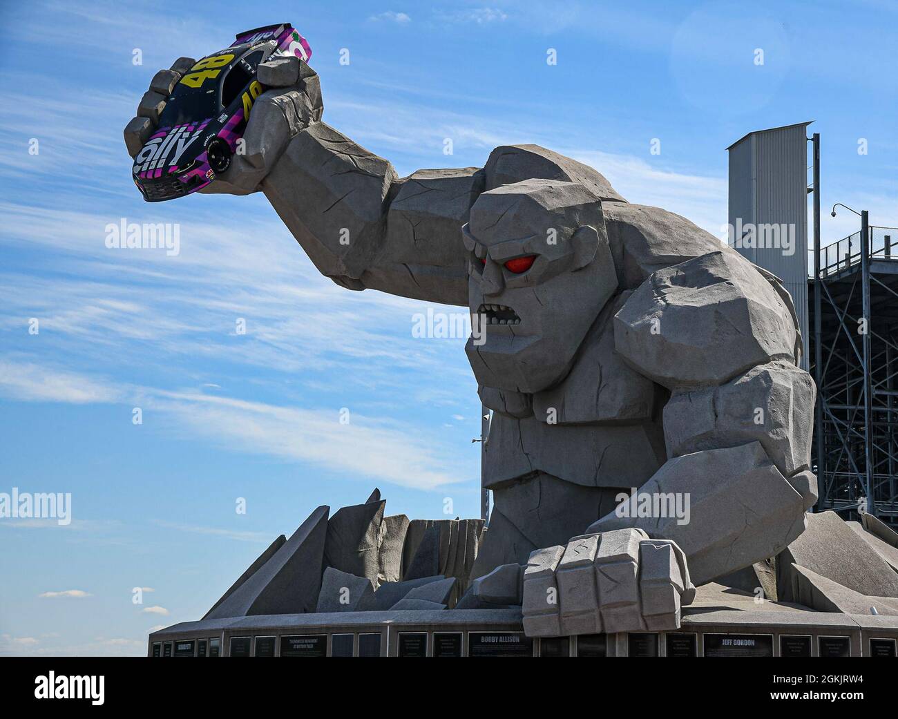 Miles the Monster holds a race car above Victory Plaza at Dover ...