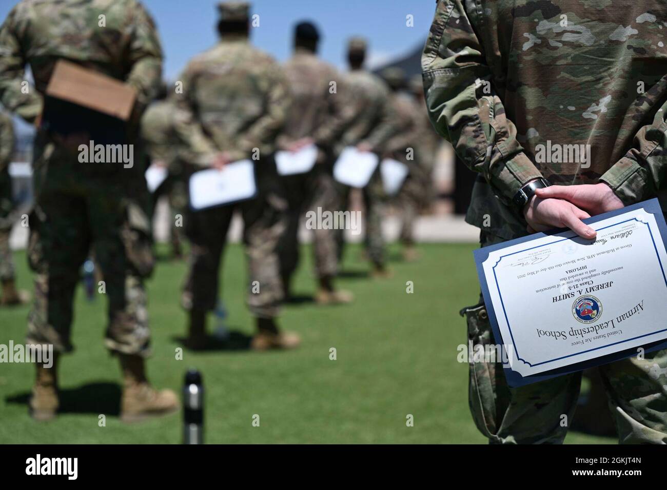Graduates from Airman Leadership School stand in formation after ...