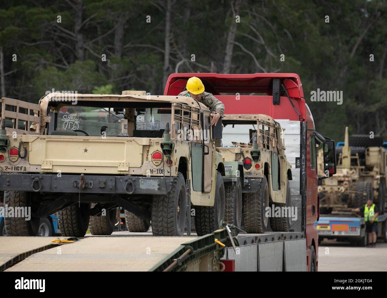 A U.S. Soldier pushes a Humvee mirror in as it is line hauled from ...
