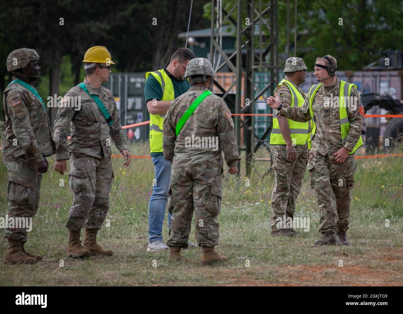 U.S. Soldiers coordinate with a British movement controller as more ...