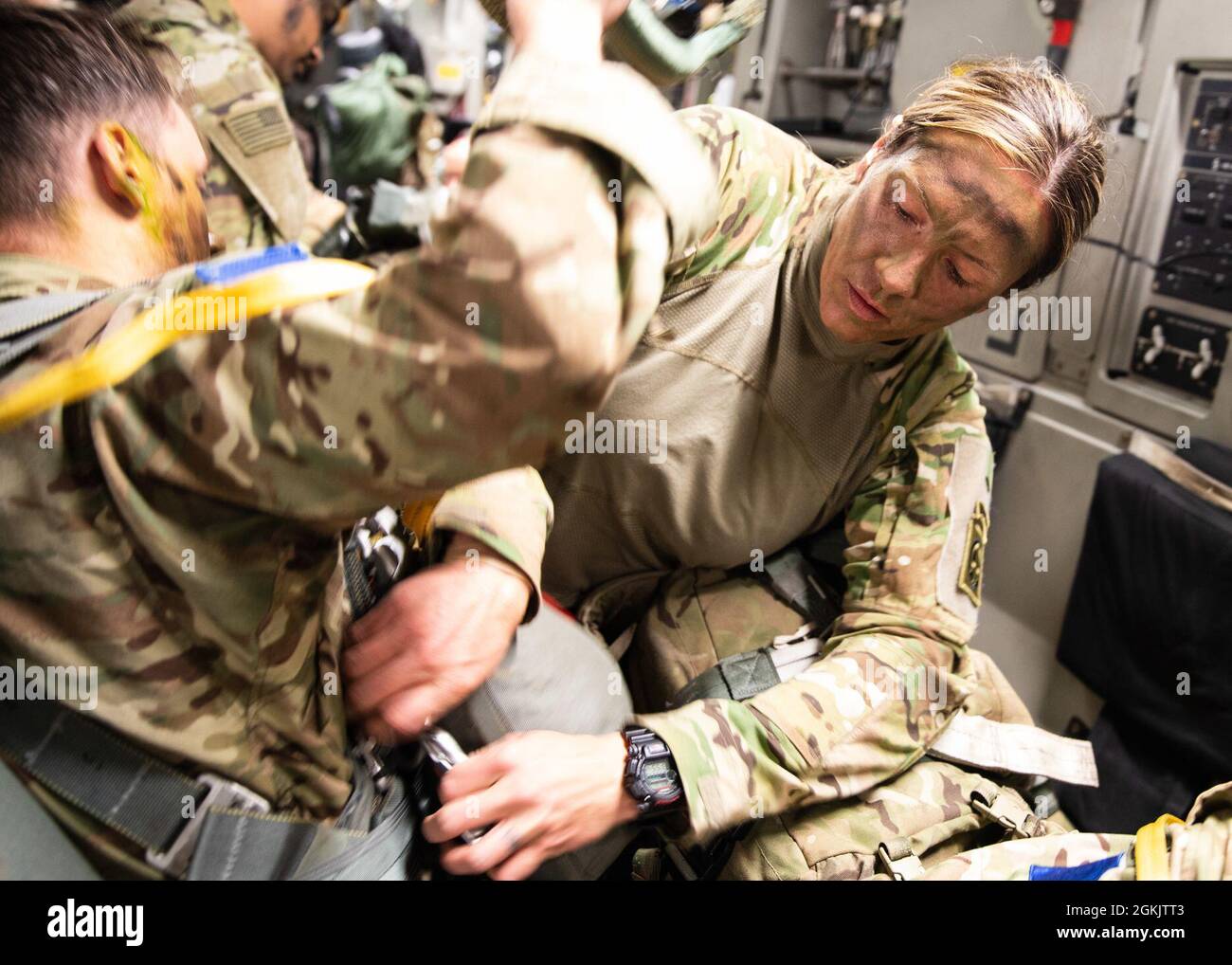 An 82nd Airborne Division Jumpmaster hangs combat equipment on a ...