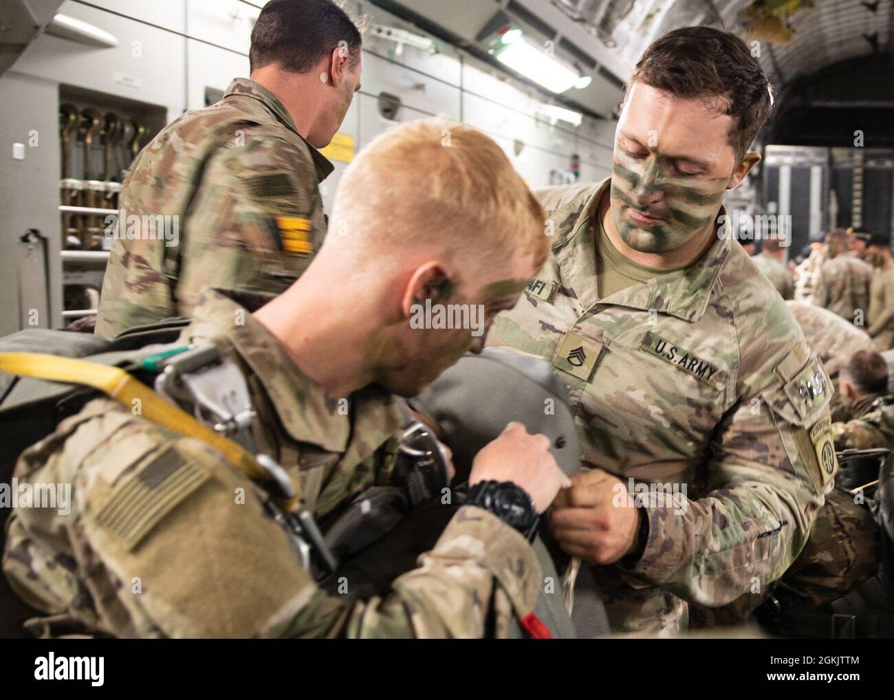 An 82nd Airborne Division Jumpmaster hangs combat equipment on a ...