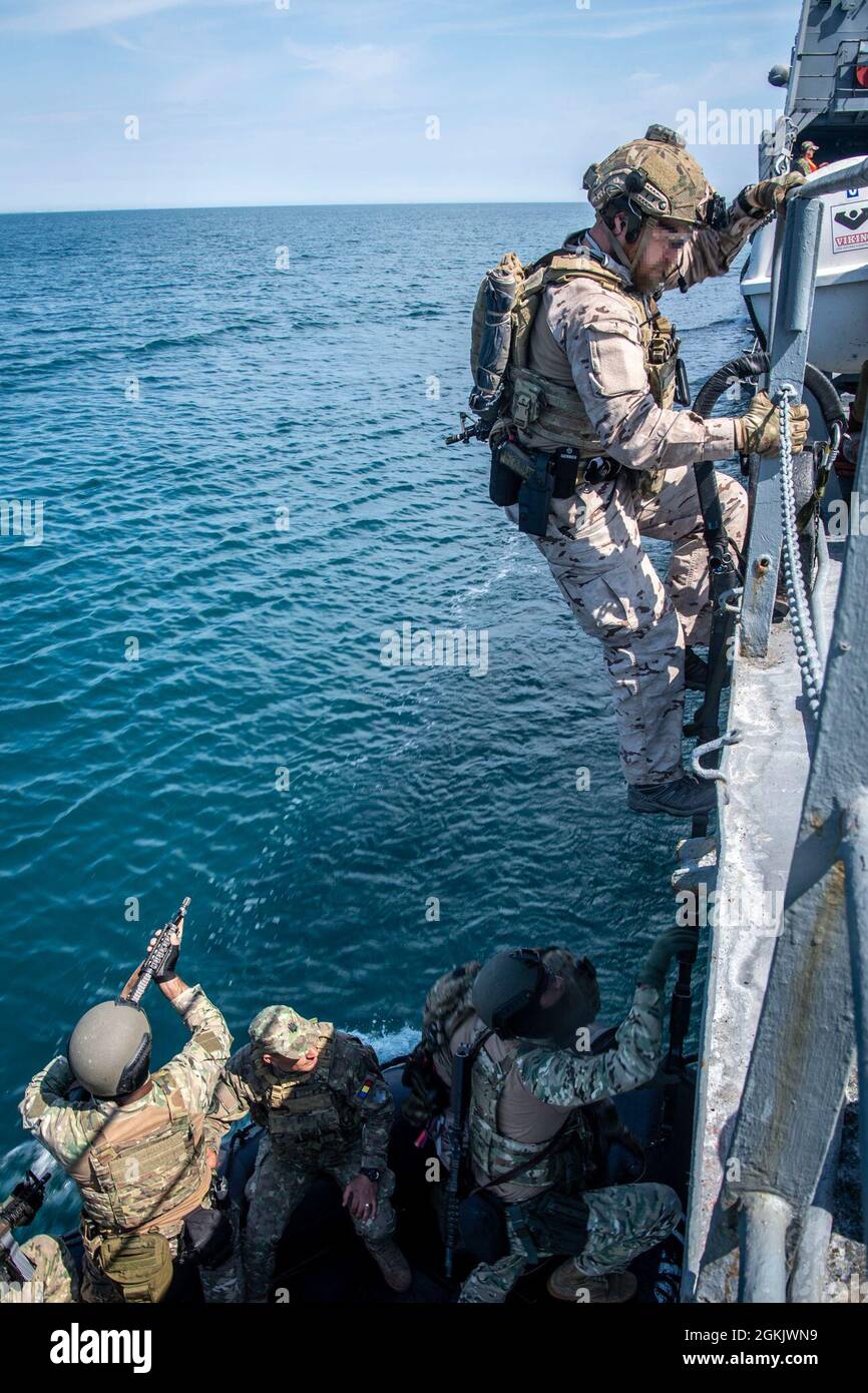 A member of the Spanish Special Forces boards a vessel during a visit ...