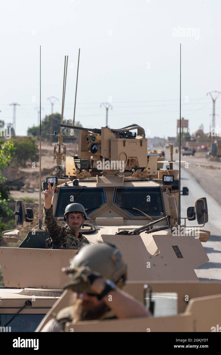 Syrian Democratic Force soldiers conduct a patrol during a joint ...