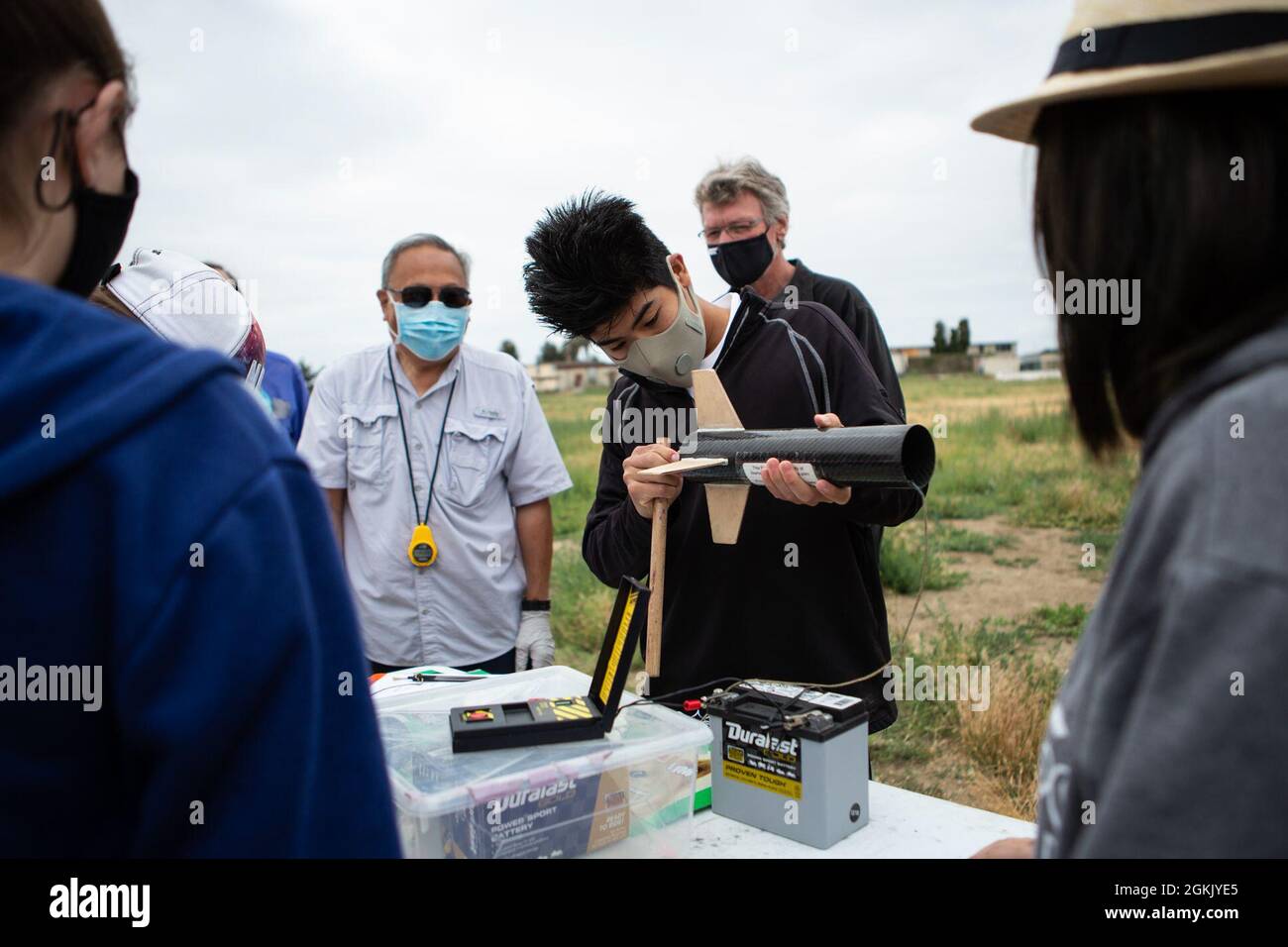 Carter Chi, a high school freshman, inspects the parachute inside a ...