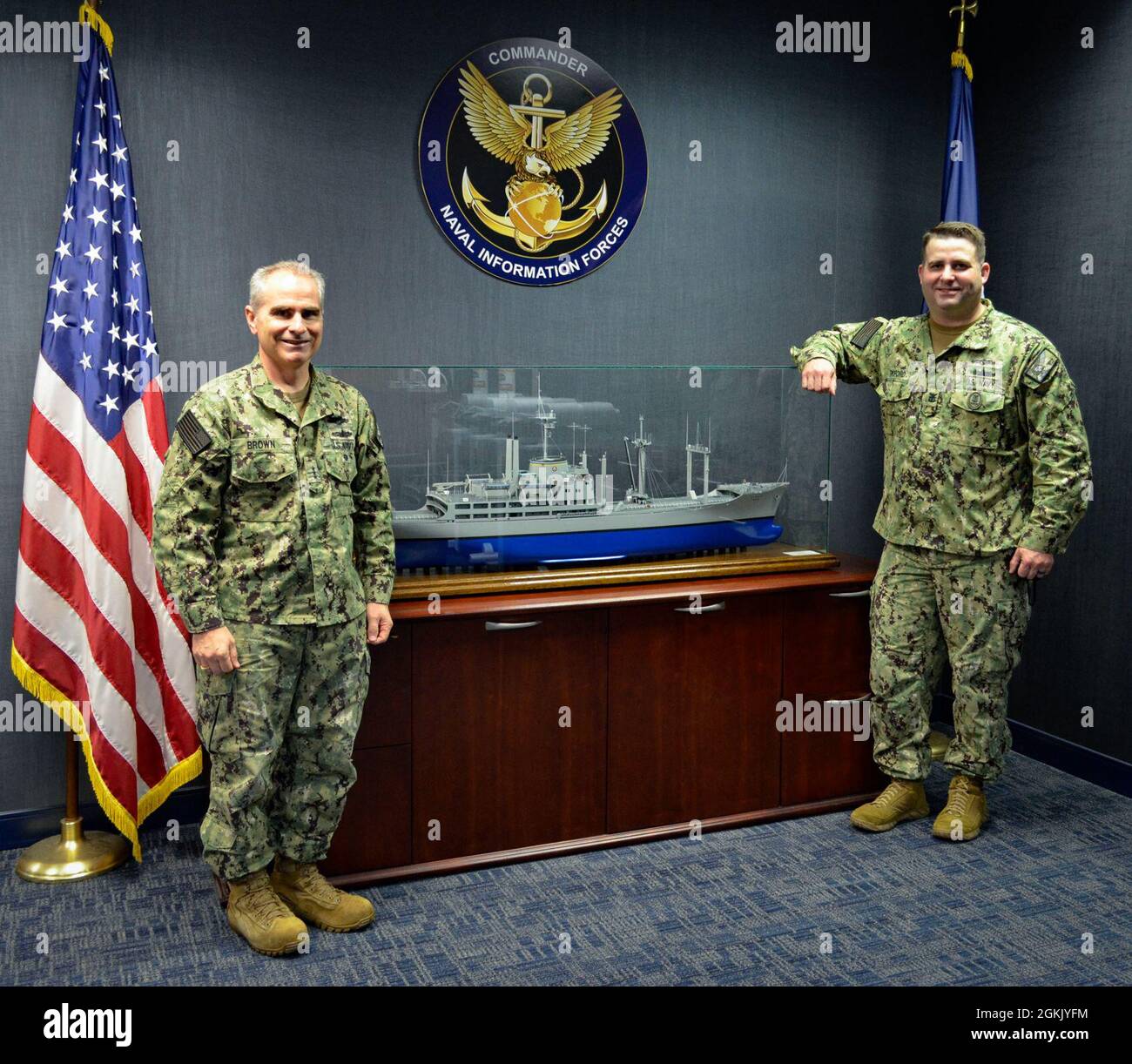 Vice Adm. Brown, Commander, NAVIFOR and Force Master Chief Twiford pose ...
