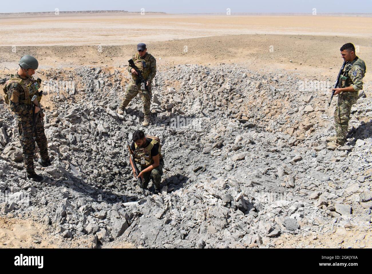 Syrian Defense Force soldiers conduct a patrol during a joint operation ...