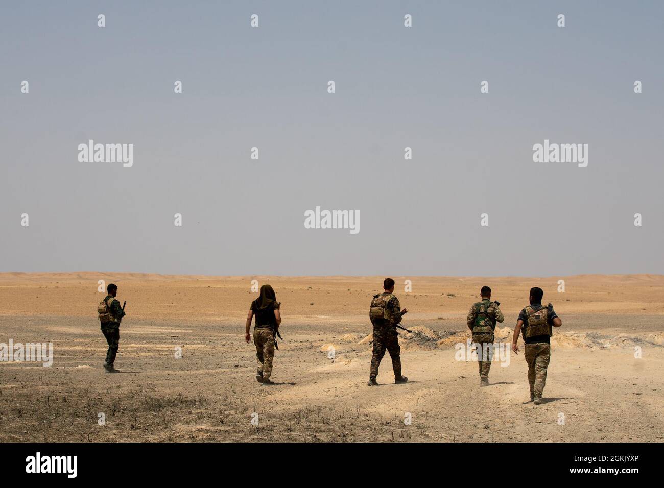 Syrian Defense Force soldiers conduct a patrol during a joint operation ...