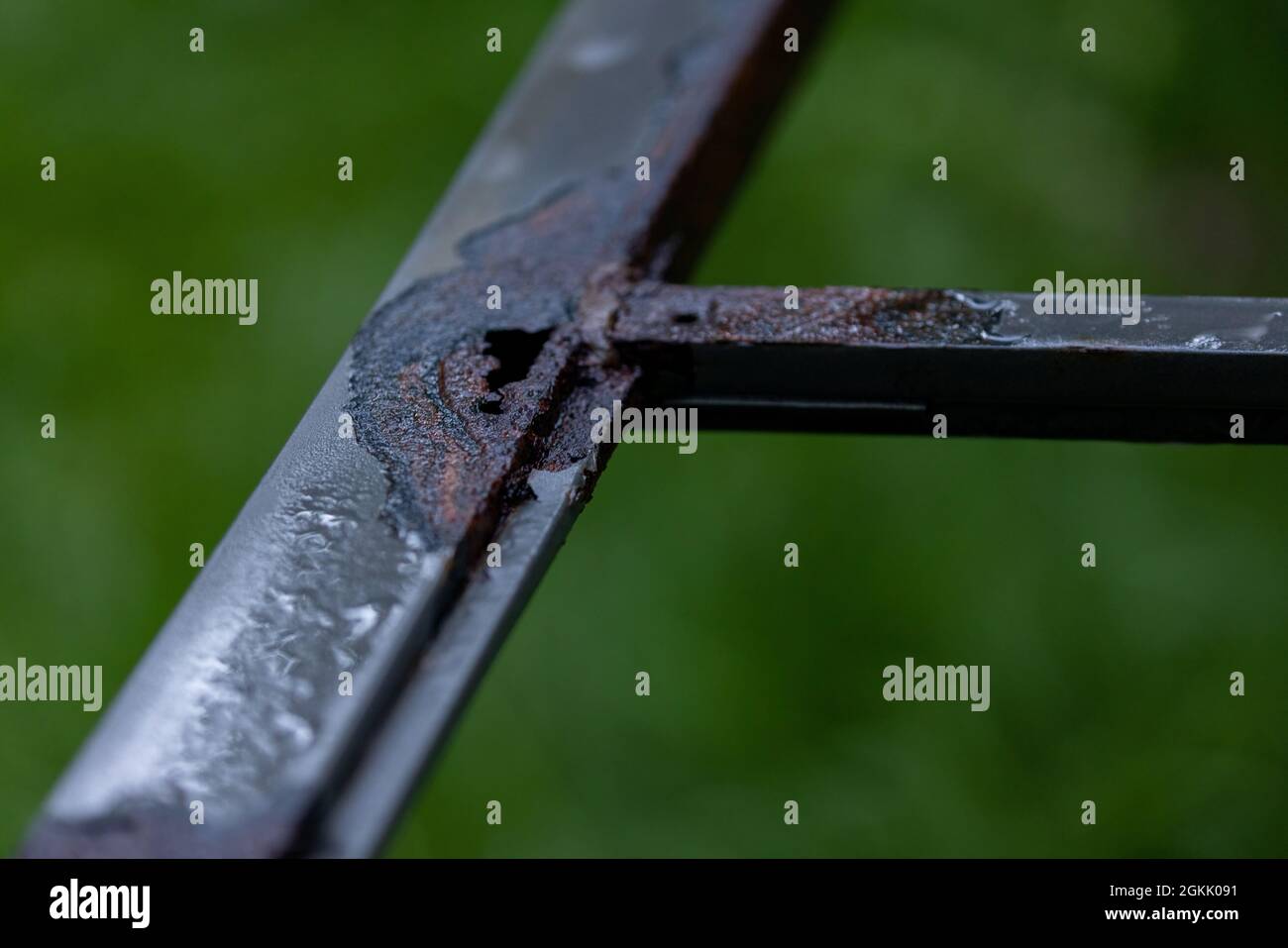 Old damaged metal frame rusted at the corners with gaping corroded ...