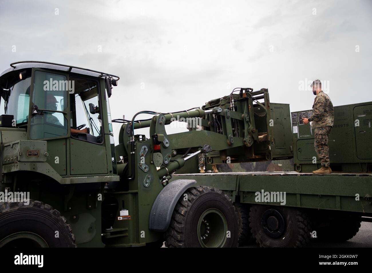 U.S. Marines with Marine Air Control Squadron (MACS) 4, unload a ...