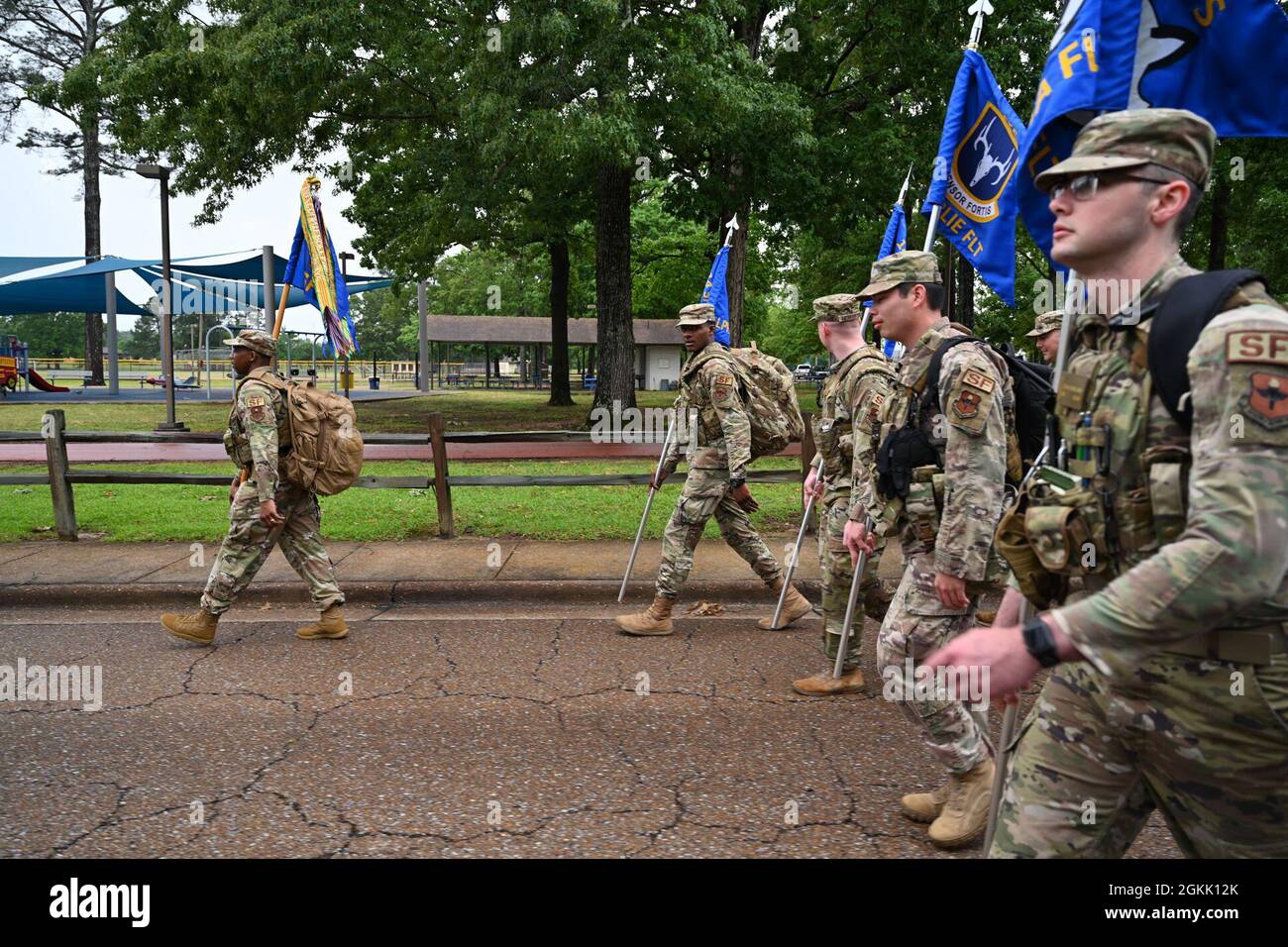 Squadrons from around the base salute the flag as reveille begins May ...
